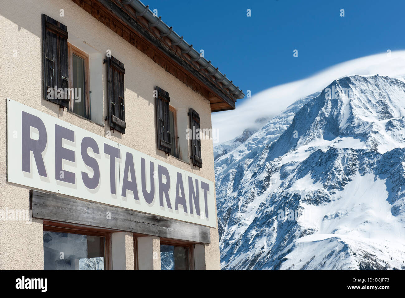 Restaurant with snow-capped mountain in background Stock Photo - Alamy