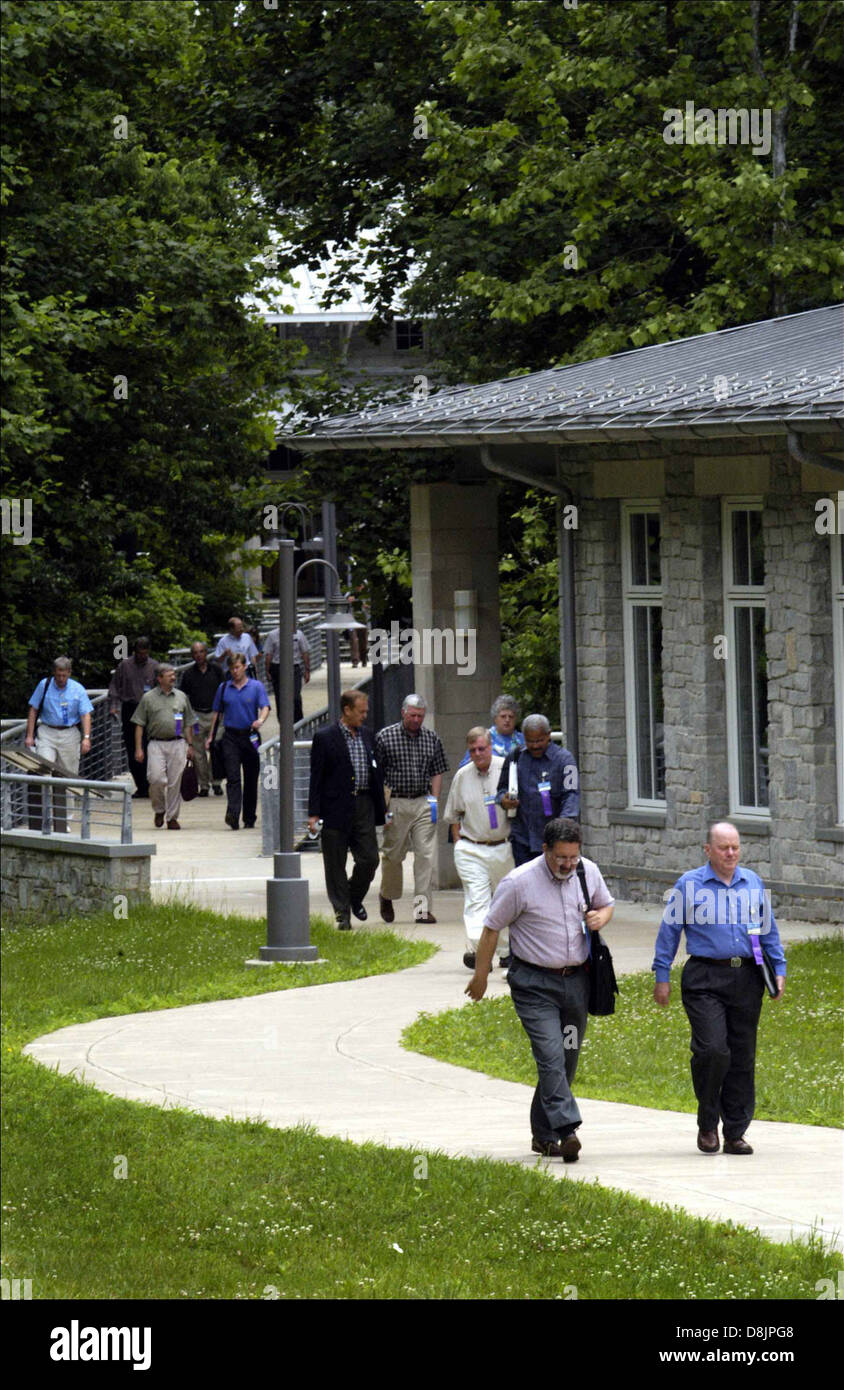 A group of people walking across a college or university campus, likely ...