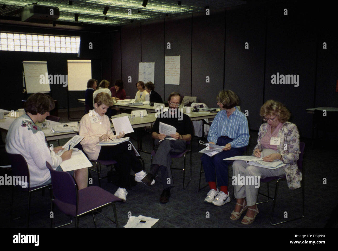 People working in small group in office Stock Photo - Alamy