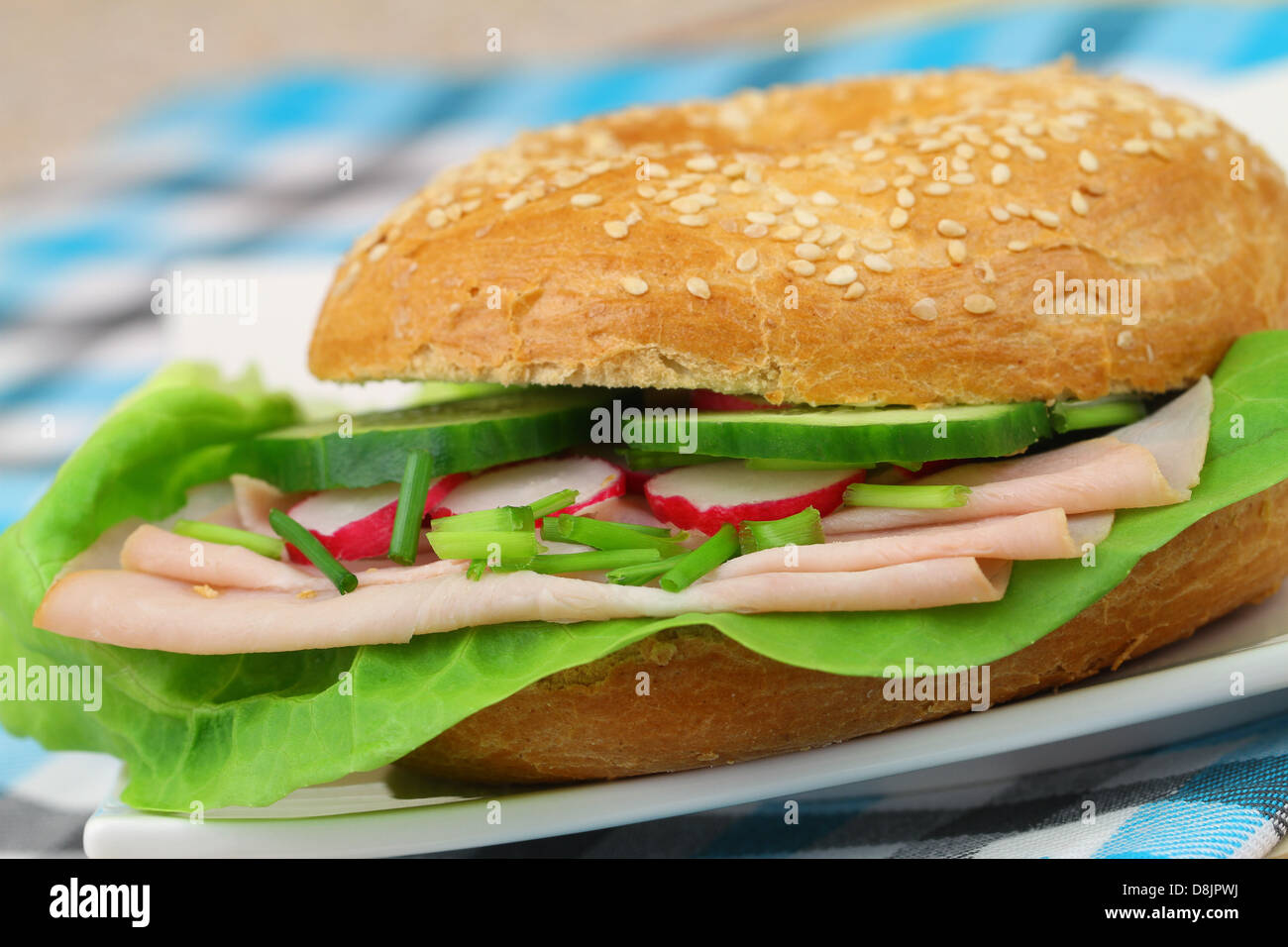 Bagel with ham, lettuce, cucumber and radish, close up Stock Photo - Alamy