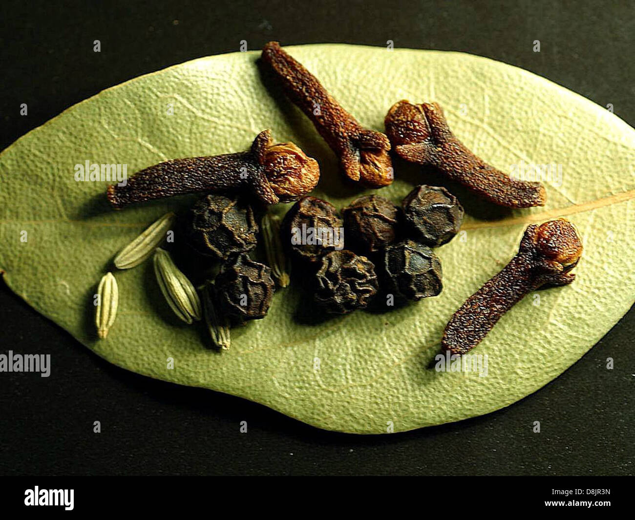 A close-up image of peppercorn seeds, showcasing their texture and ...