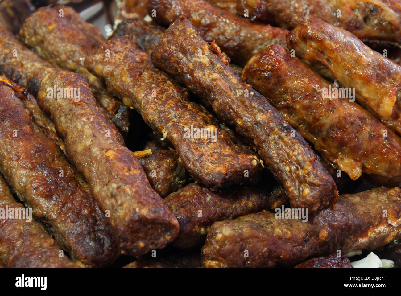 Pile of roasted long cylindric meatballs "soutzoukakia" and cypriot ...