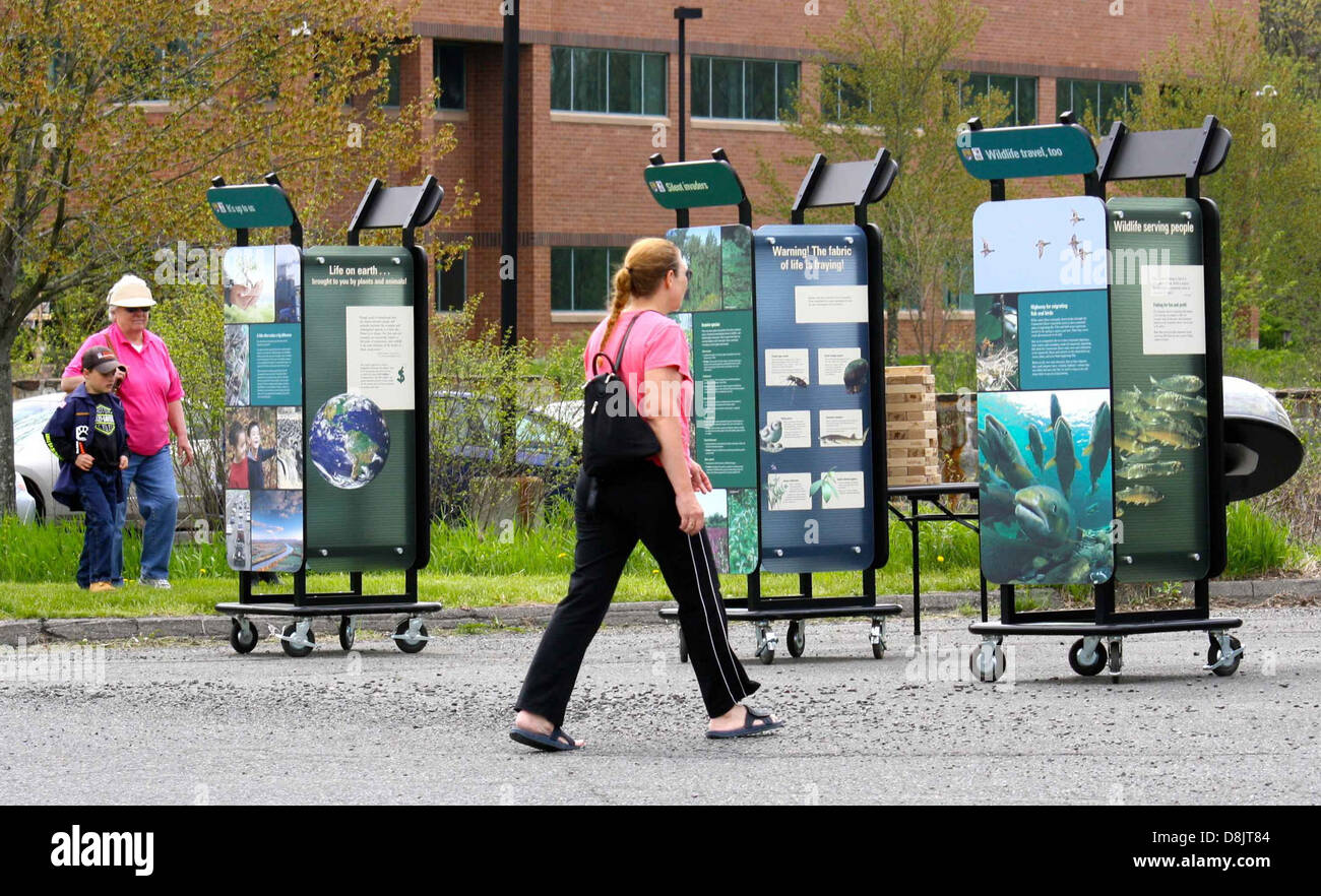 This image shows a person walking past interactive displays along a ...