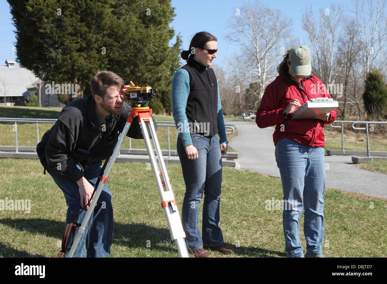 Person practice using a sight level for mapping ground Stock Photo - Alamy