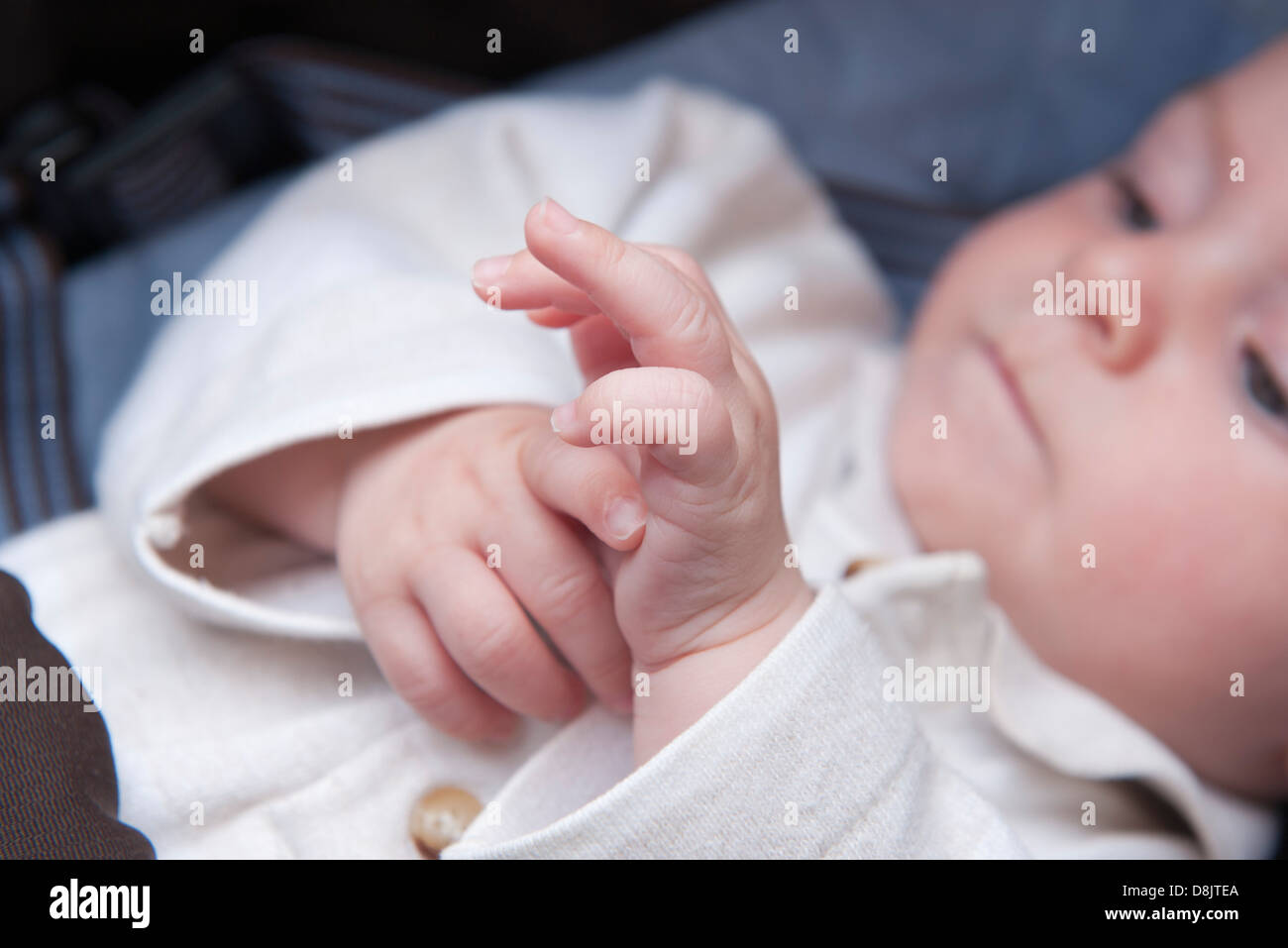 Baby's hands clasped Stock Photo - Alamy