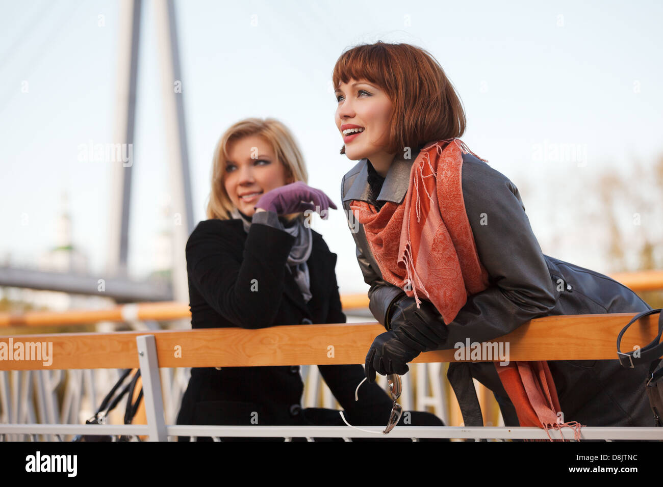Happy young women on the bench Stock Photo - Alamy