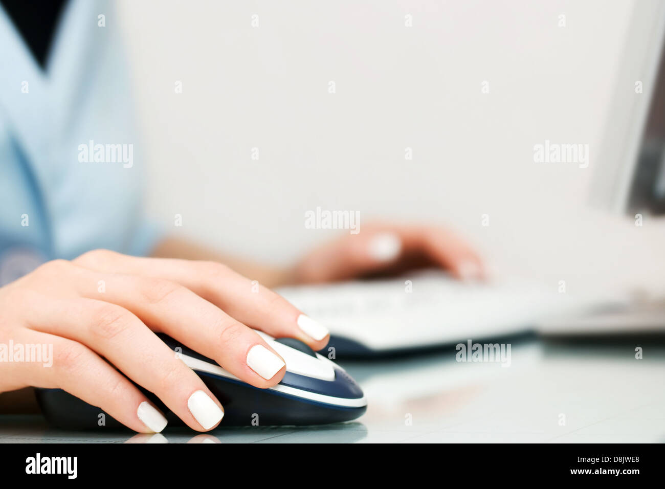 Female hand holding computer mouse Stock Photo - Alamy