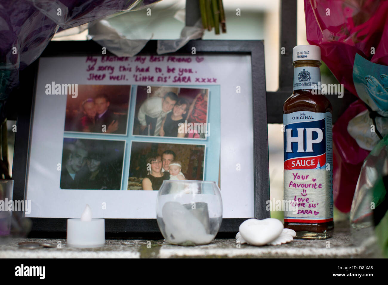 Flower are left at the scene where Drummer Lee Rigby was killed outside ...