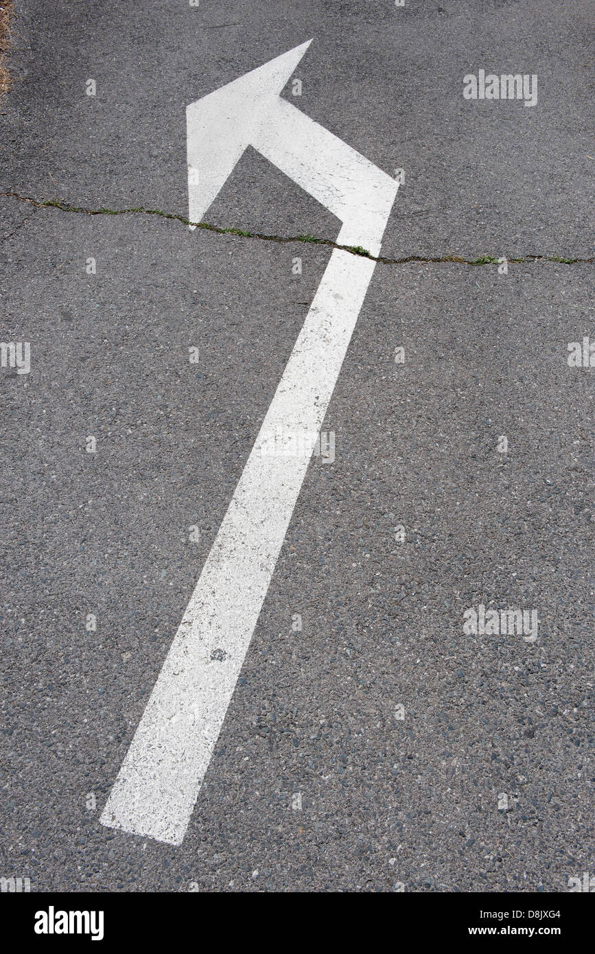 Direction arrow on pavement Stock Photo - Alamy