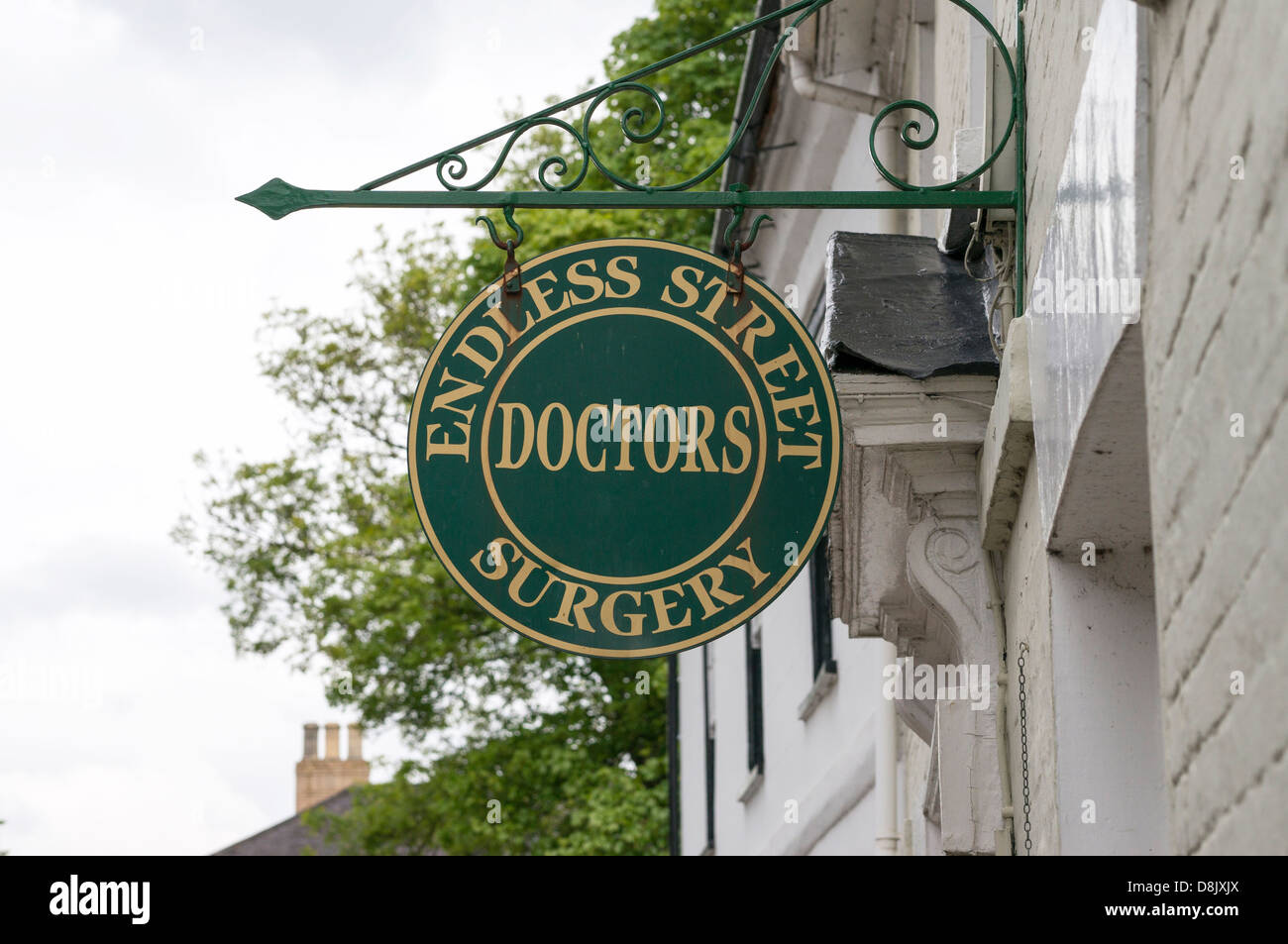 Metal Doctors surgery sign hanging from an ornate wrought iron bracket ...