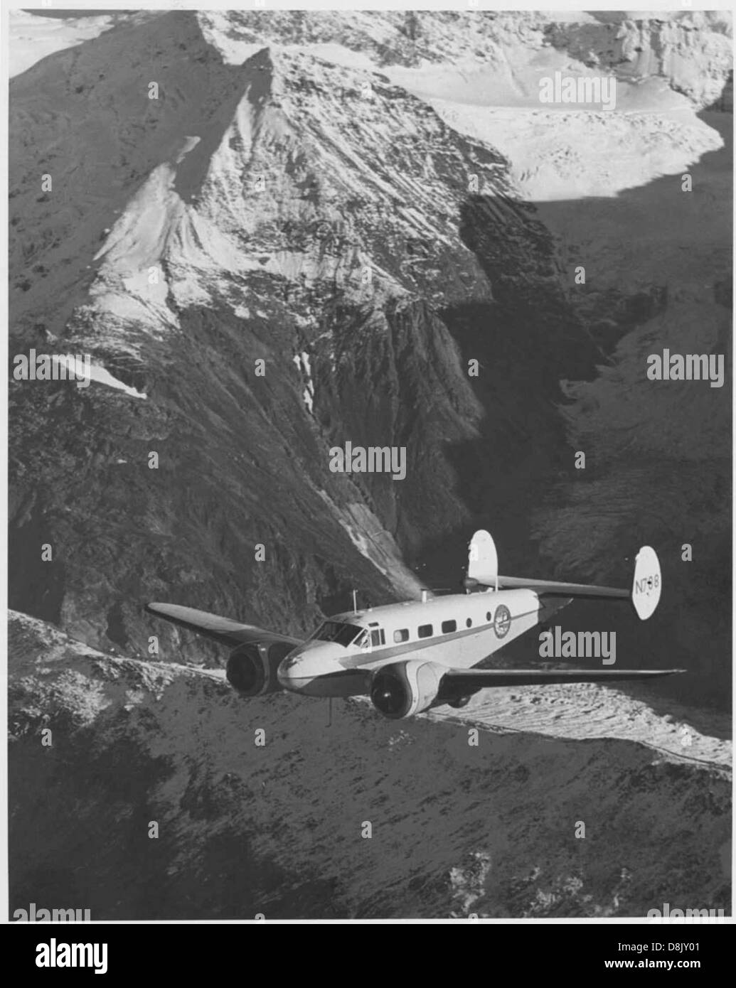 Plane flying over mountains vintage photo Stock Photo - Alamy
