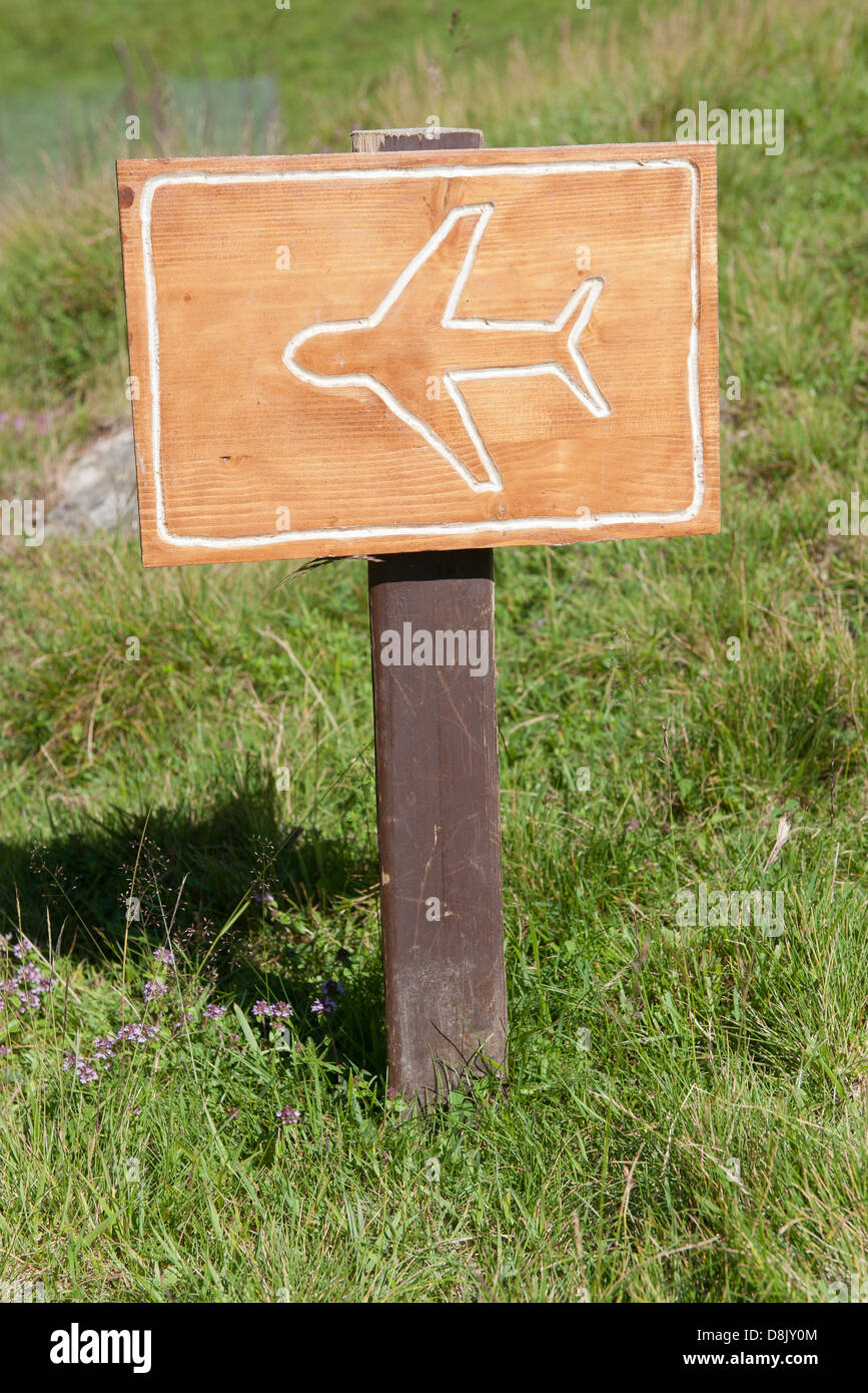 Wooden sign with symbol of air plane Stock Photo - Alamy