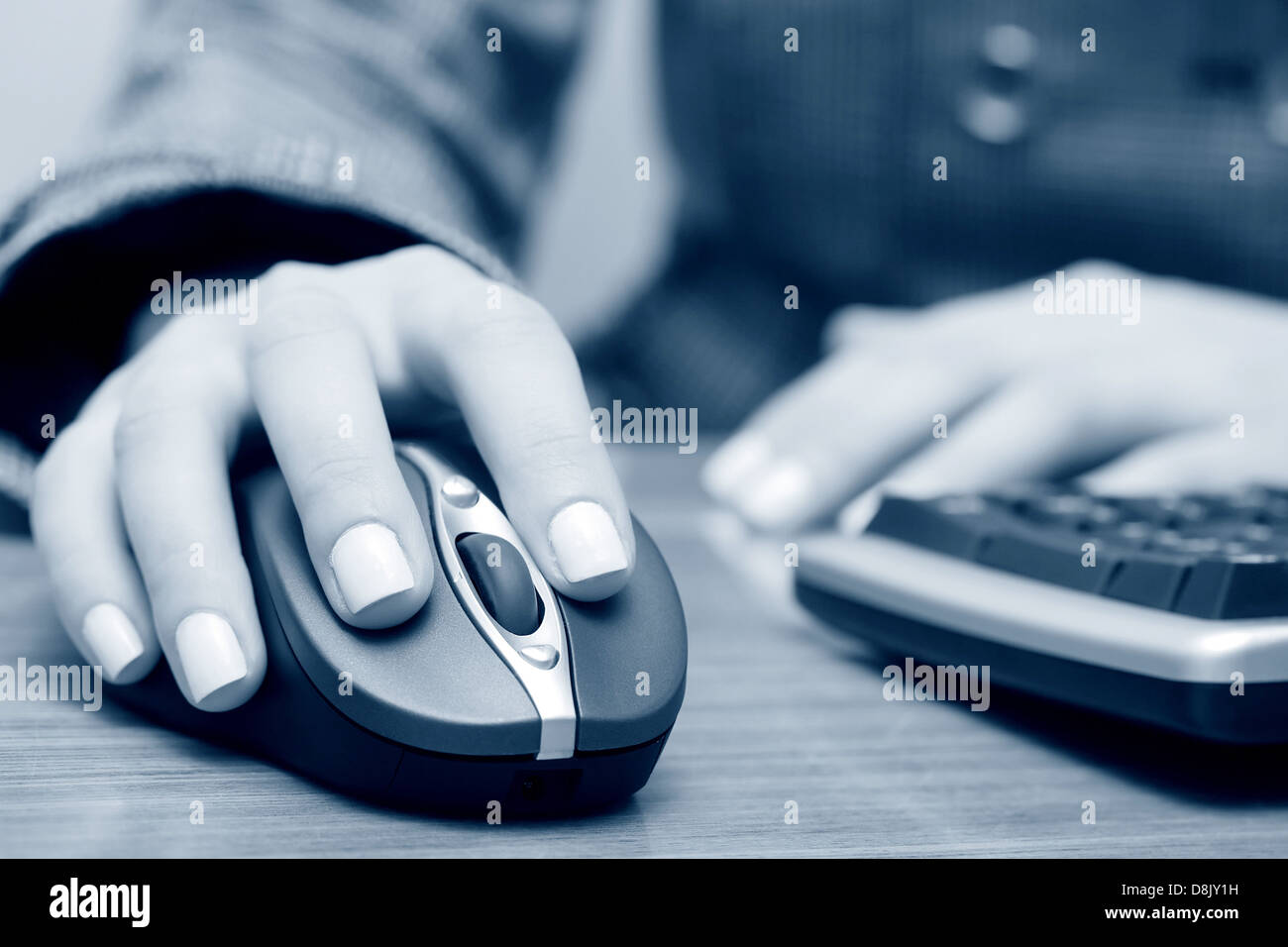 Female hand holding computer mouse Stock Photo - Alamy