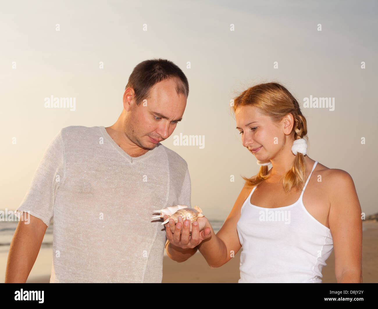 Man listening to seashell hi-res stock photography and images - Alamy