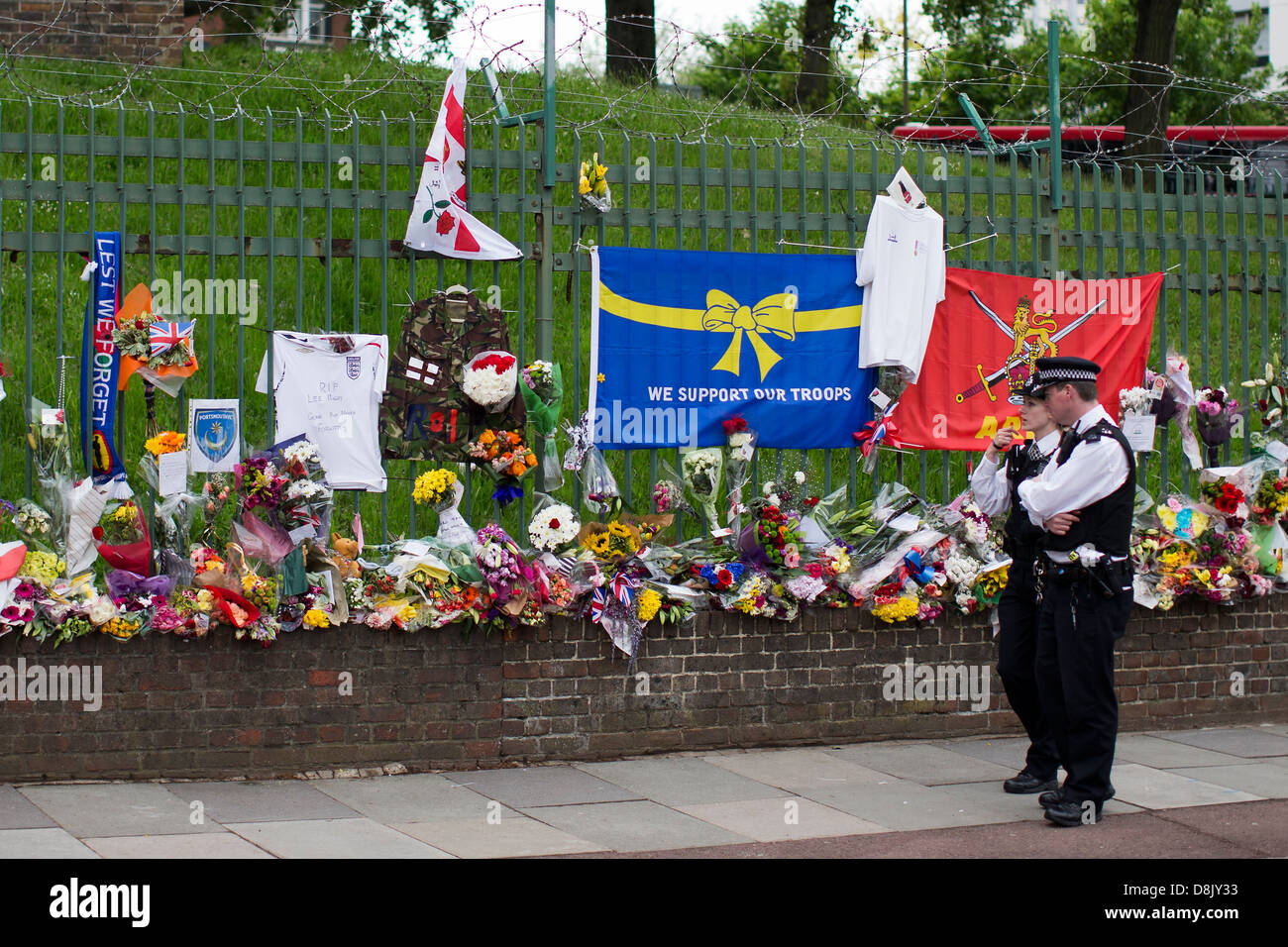 Flower are left at the scene where Drummer Lee Rigby was killed outside ...