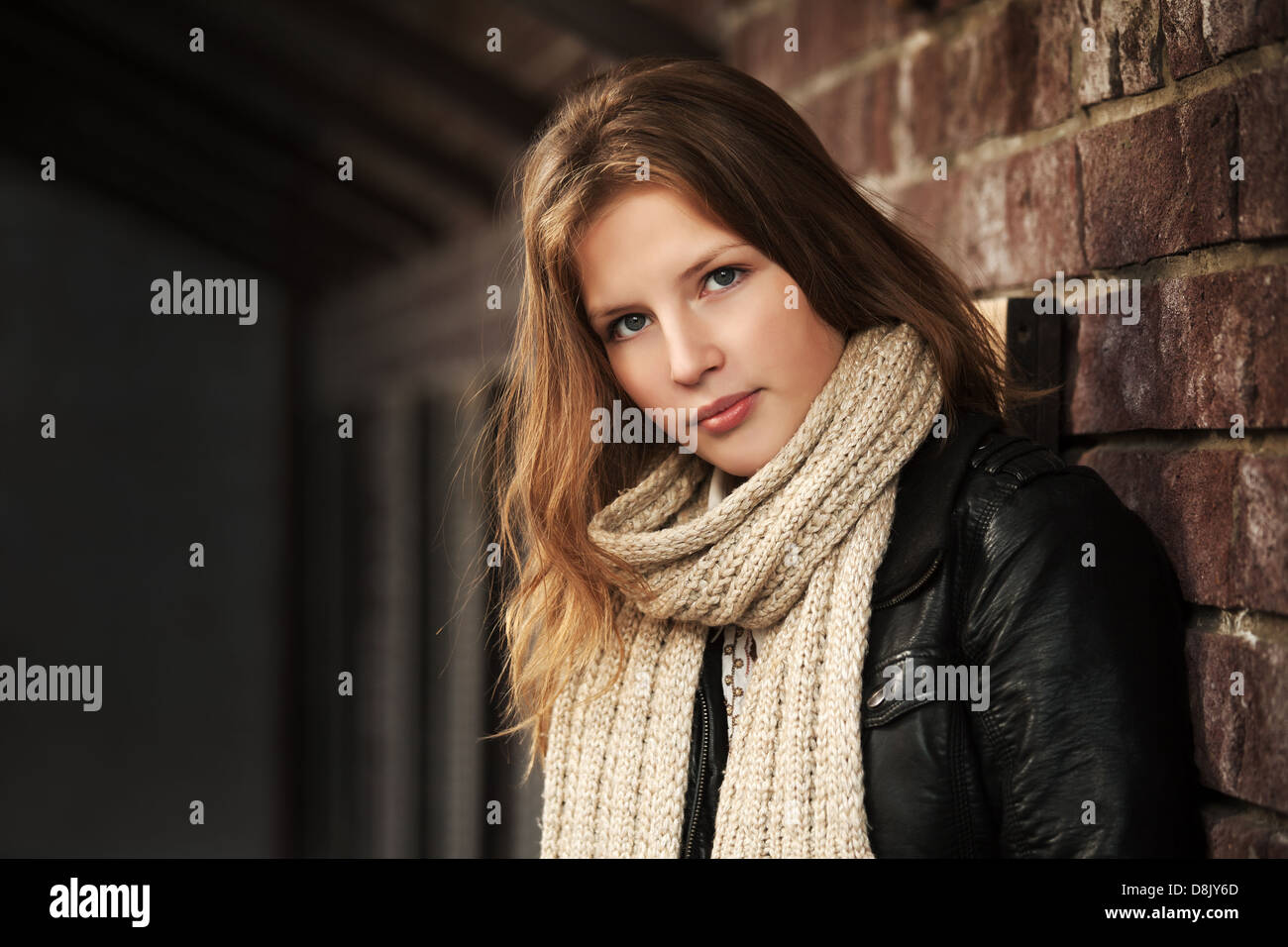 Teenage girl against a brick wall Stock Photo - Alamy
