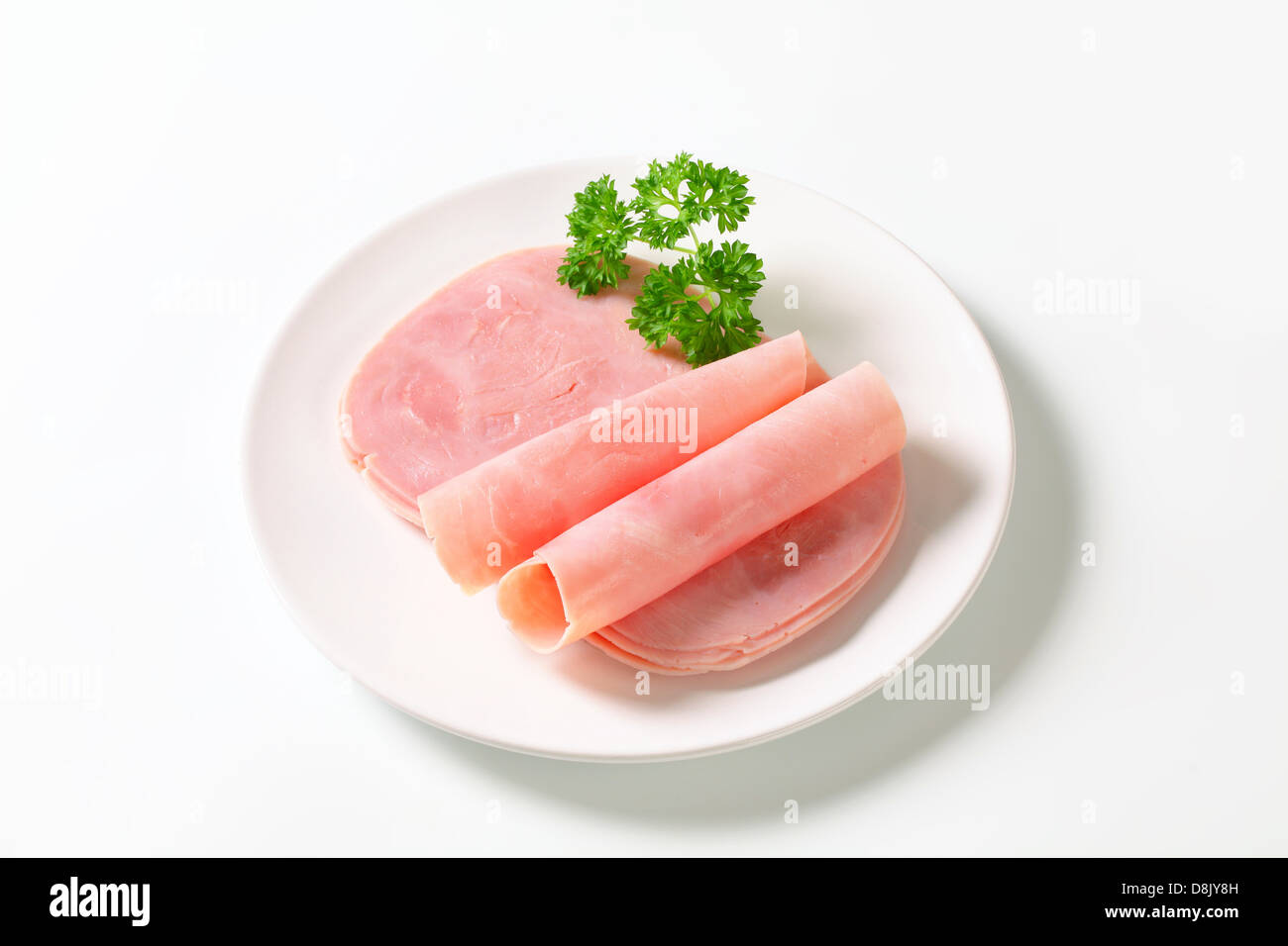 Thinly sliced ham on plate Stock Photo - Alamy