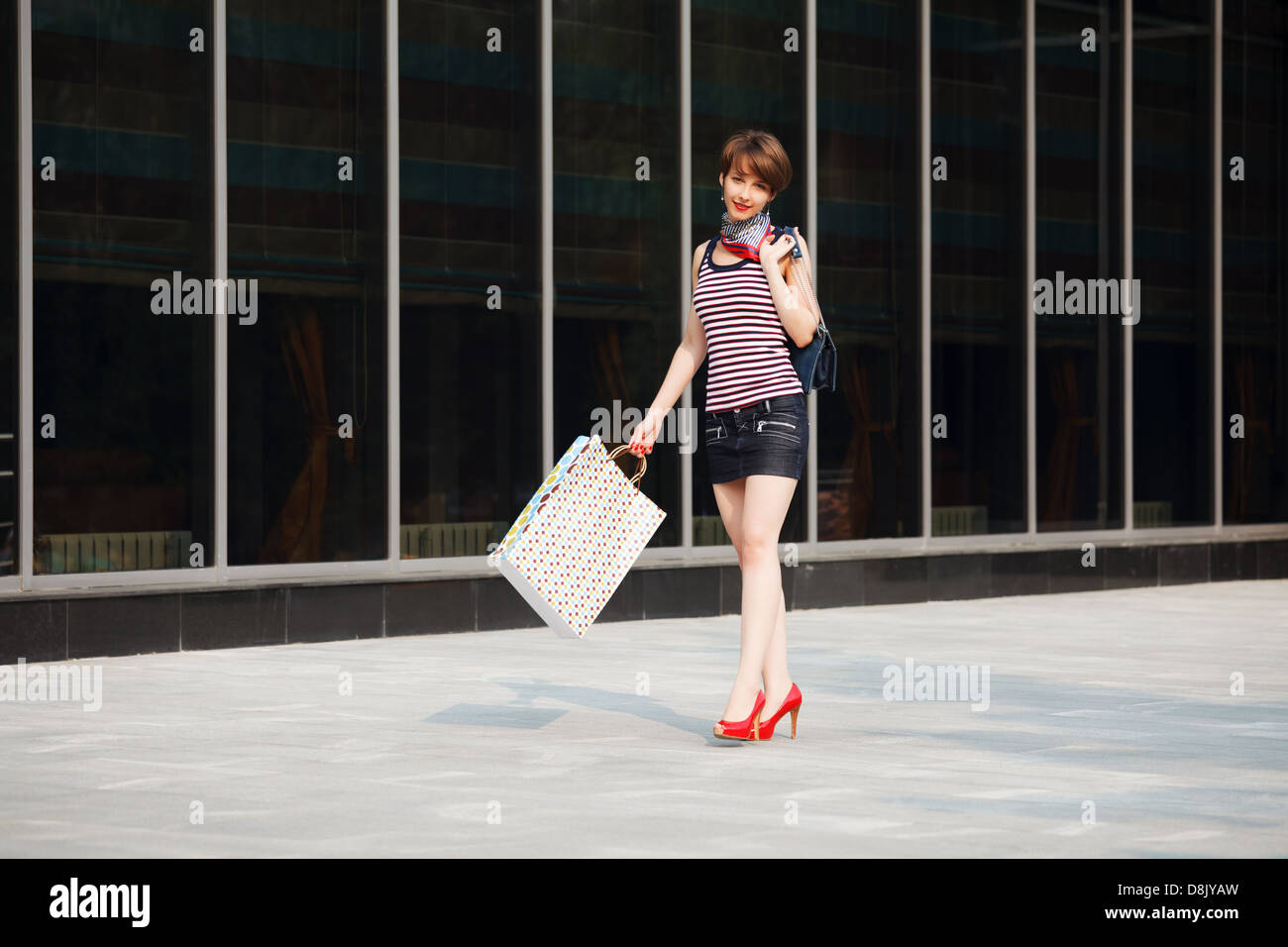 Young woman against a shop window Stock Photo - Alamy
