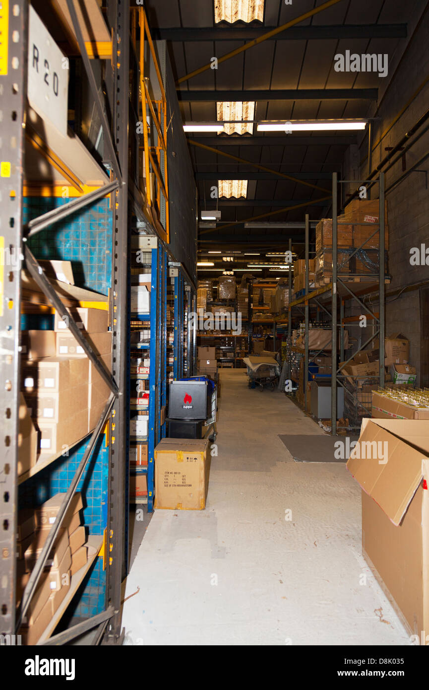 Large Warehouse with cardboard boxes pilled high on racking system ...