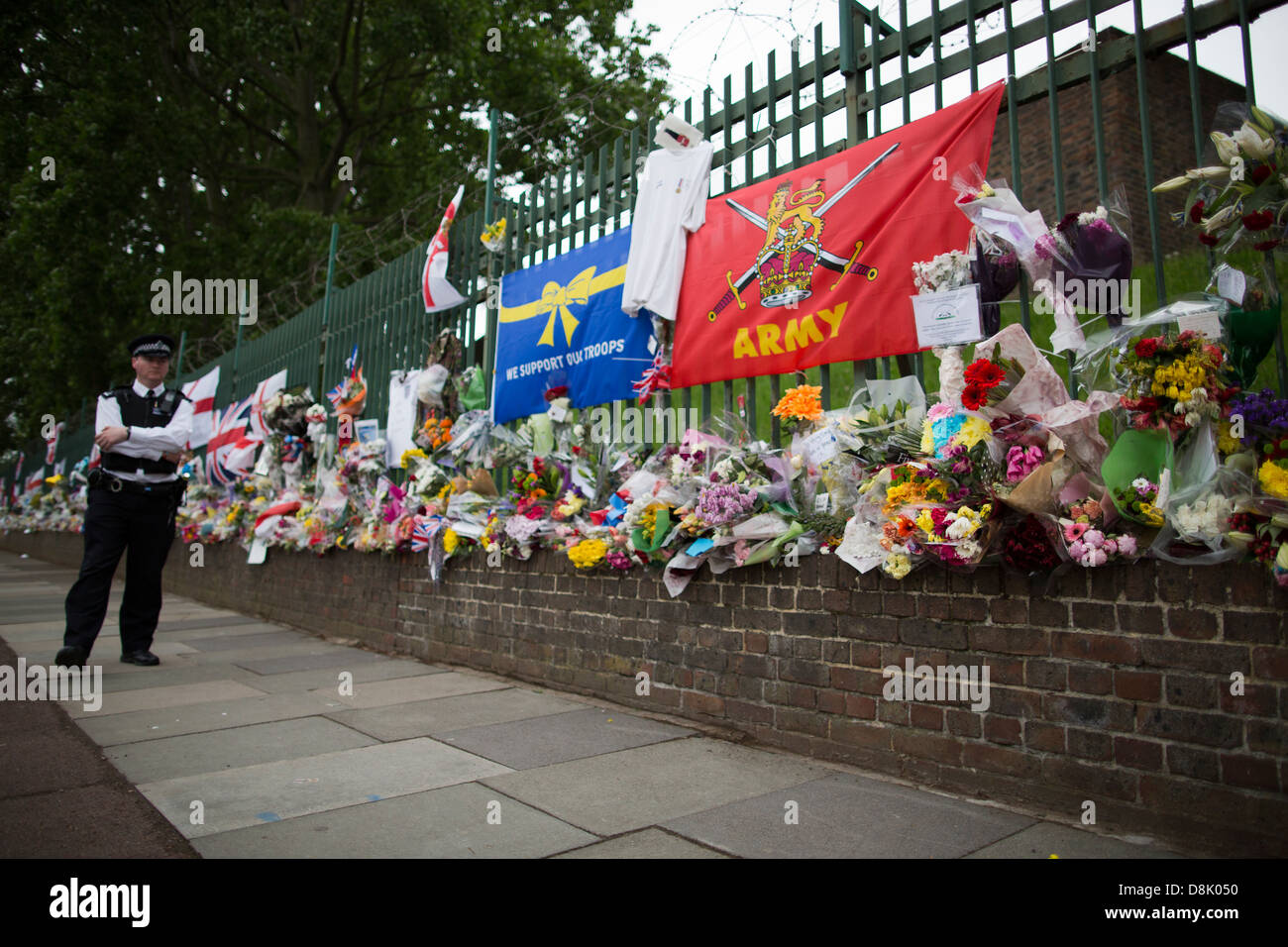 Flower are left at the scene where Drummer Lee Rigby was killed outside ...