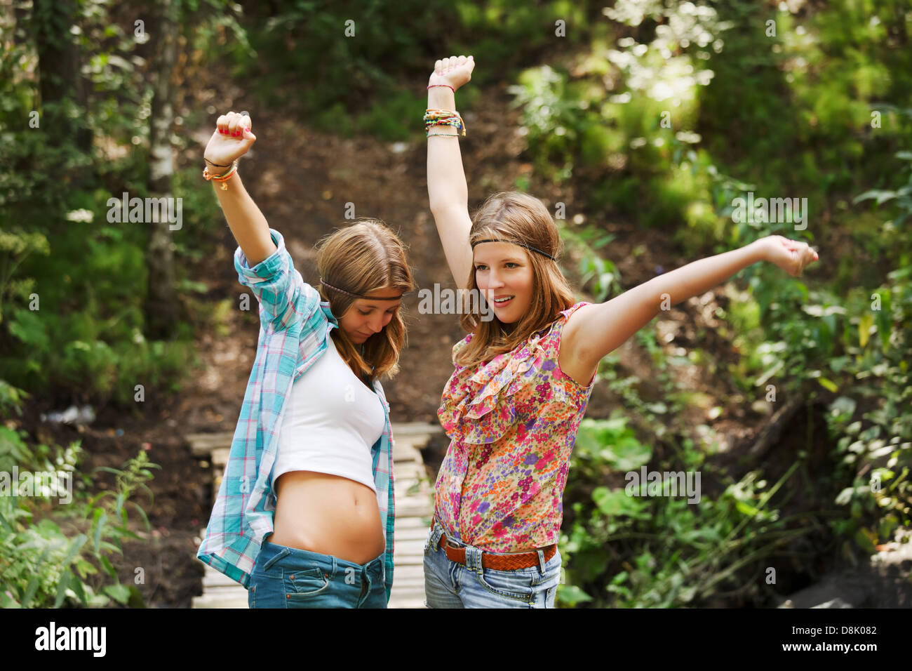Young girls on the wooden bridge Stock Photo - Alamy