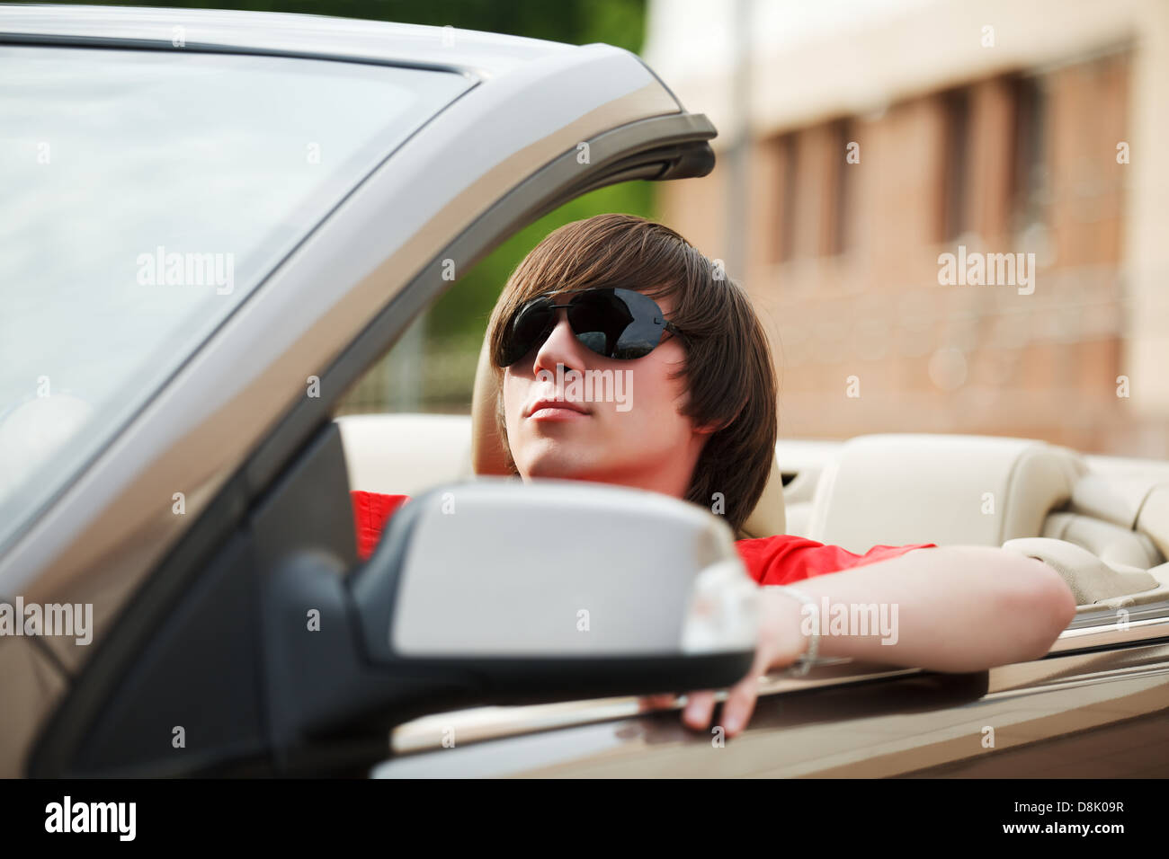 Young man driving a convertible car Stock Photo - Alamy