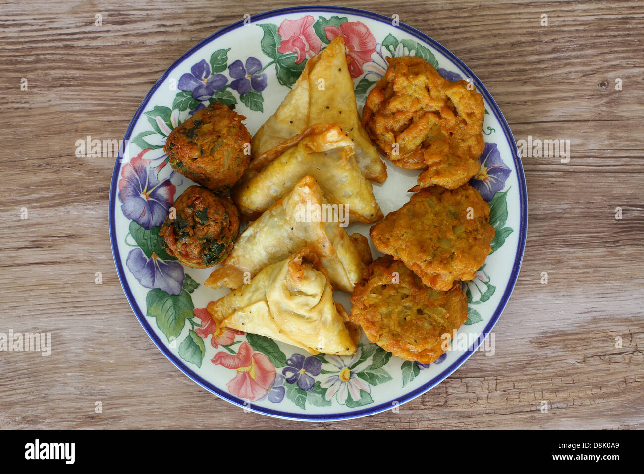 Selection of Indian vegetarian starters on vintage plate on wooden ...