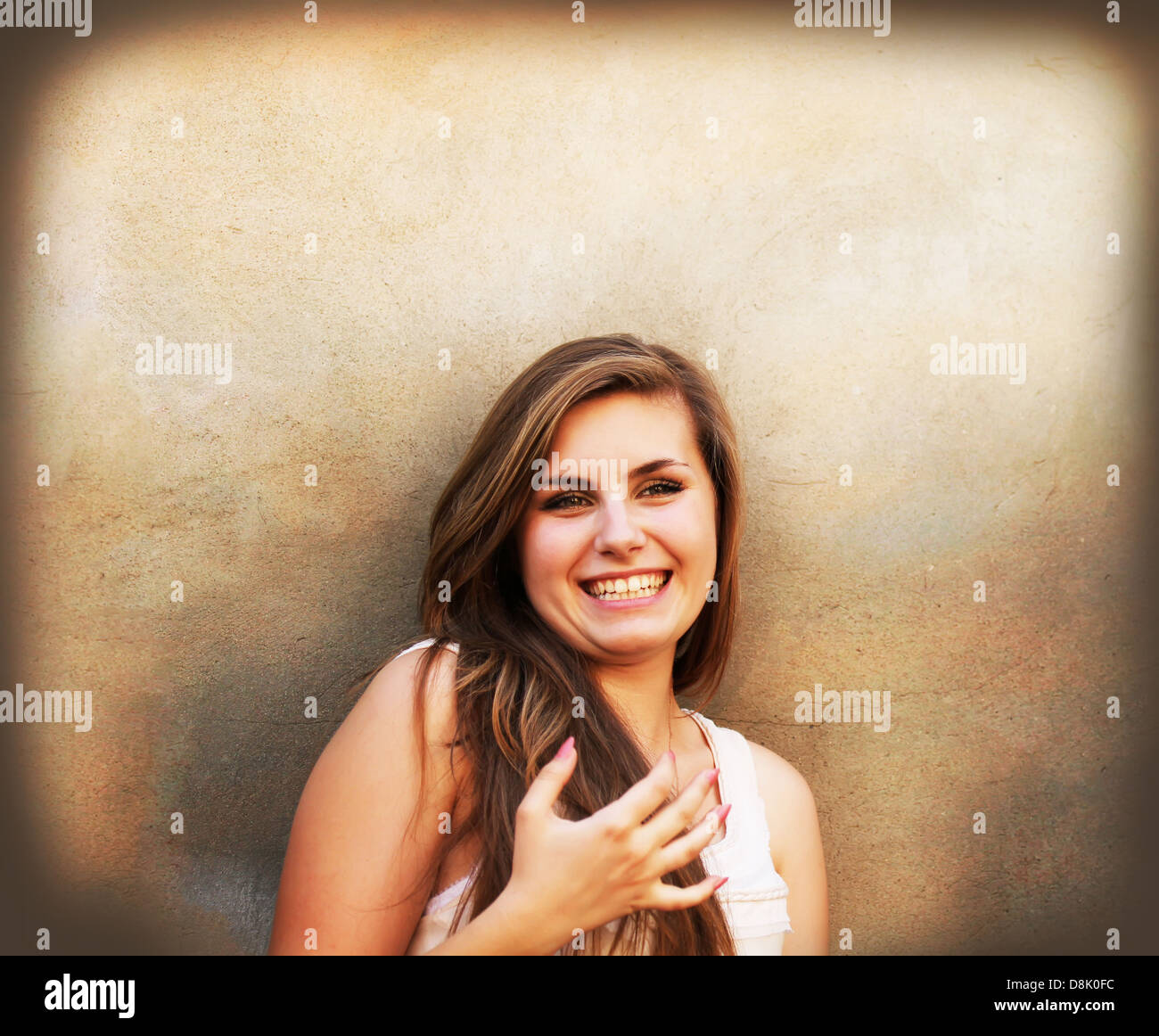 Beautiful girl smiling on background of the vintage wall Stock Photo ...