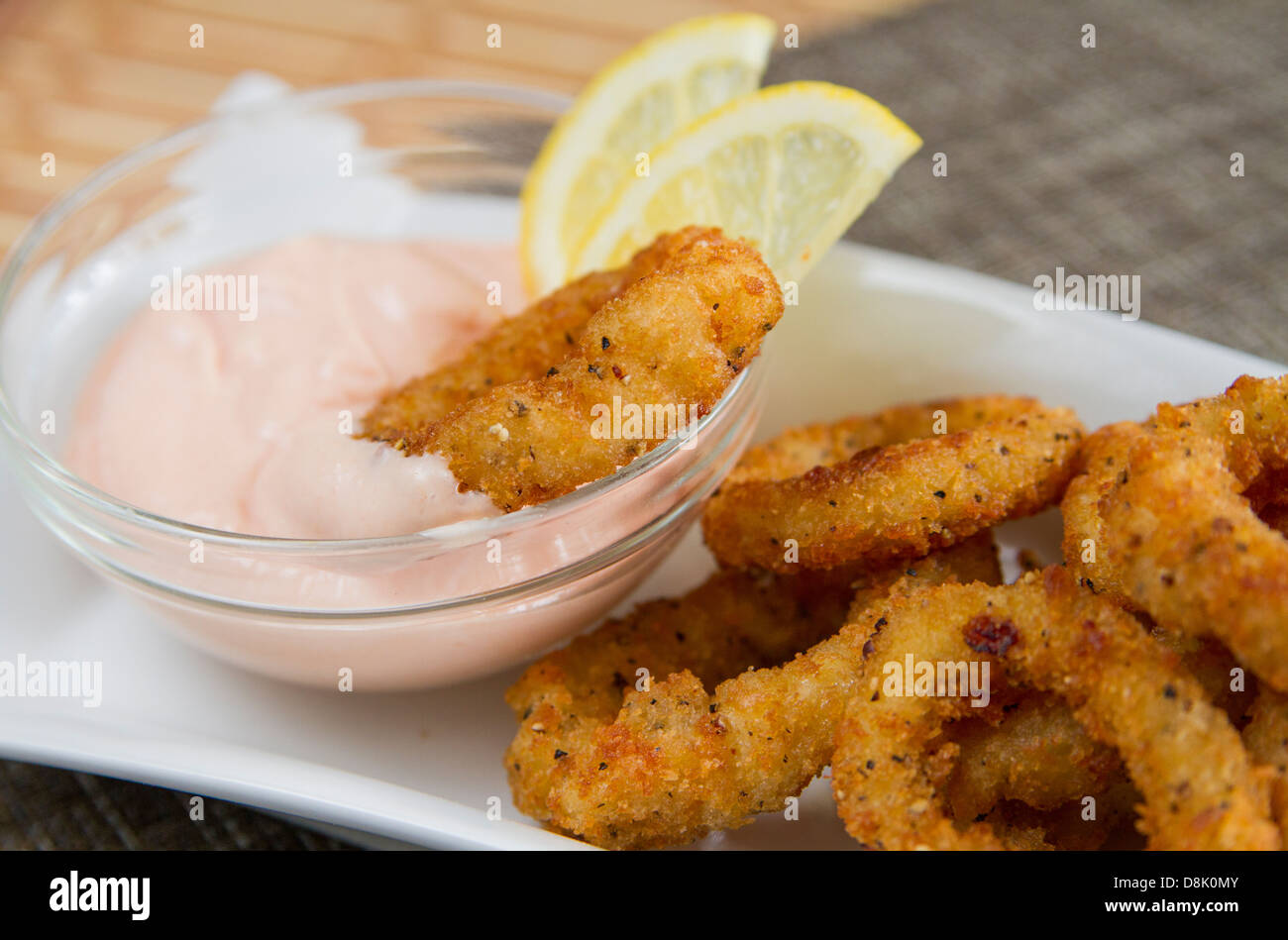 Plate of Delicious Fried calamari with sauce Stock Photo - Alamy