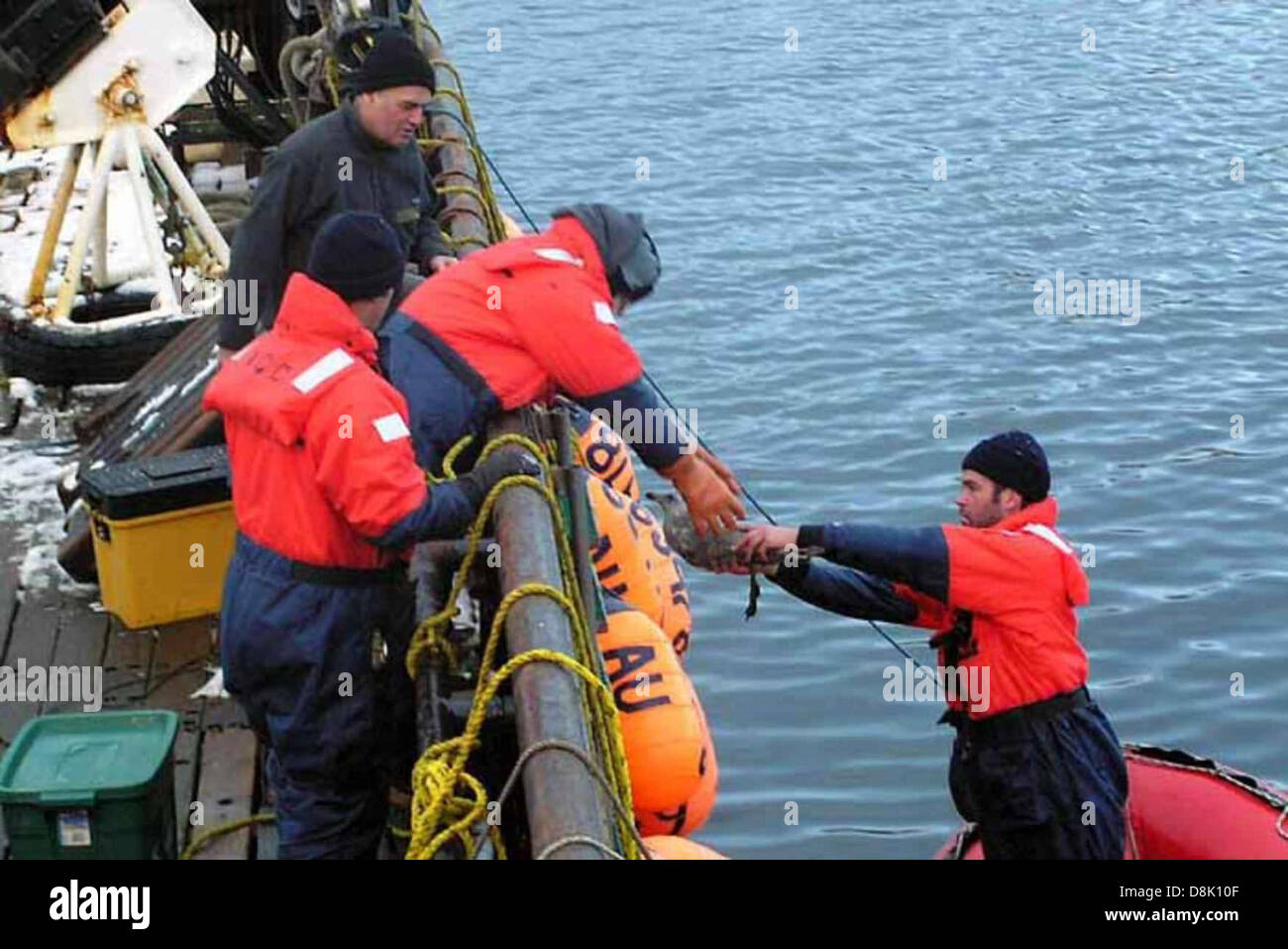 This image shows a rescue boat tied to a larger ship, ready for use in ...