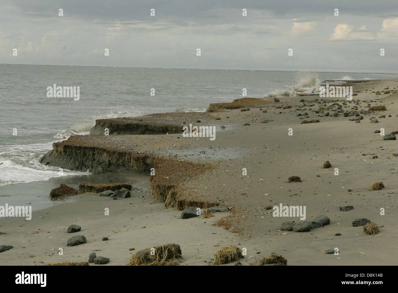 The rising ocean levels are causing erosion along a beach coast ...
