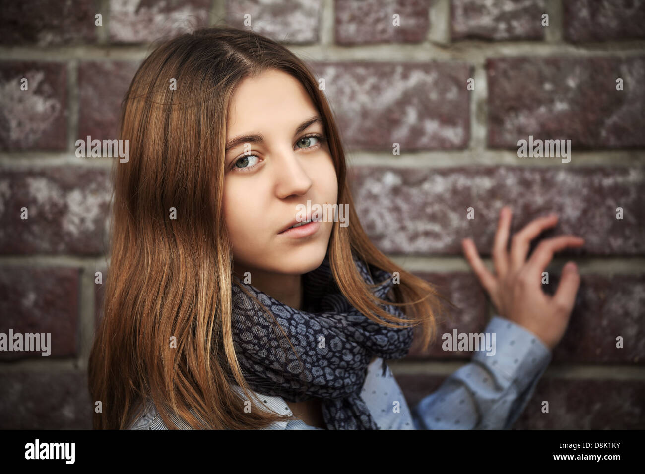 Teenage girl against a brick wall Stock Photo - Alamy