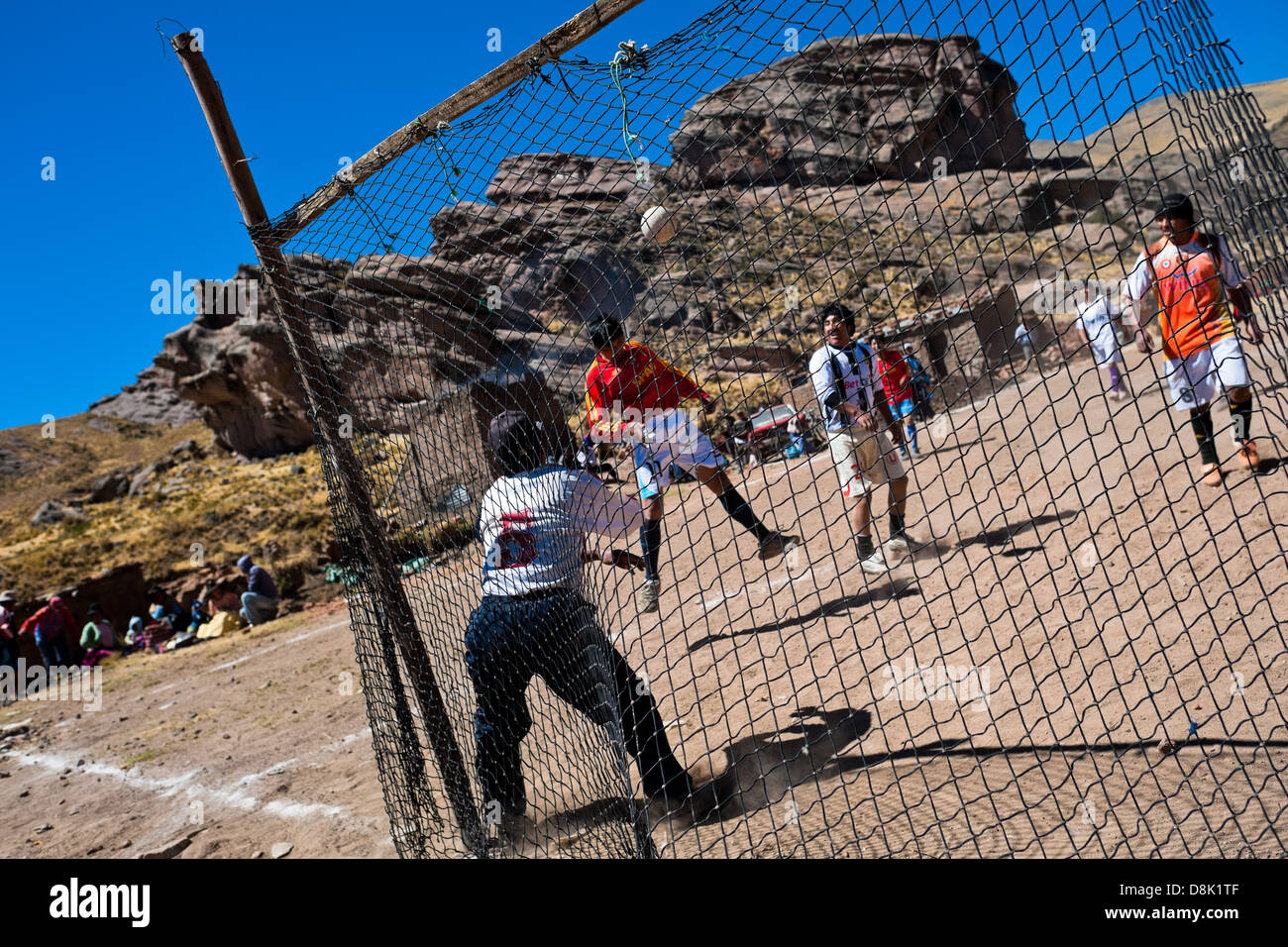 Indigenous men play football on a dirt football pitch in the rural ...