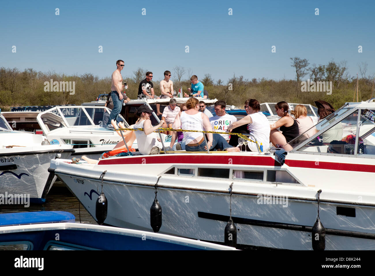 Teenagers enjoying the spring sunshine on boats, Malthouse Broad ...