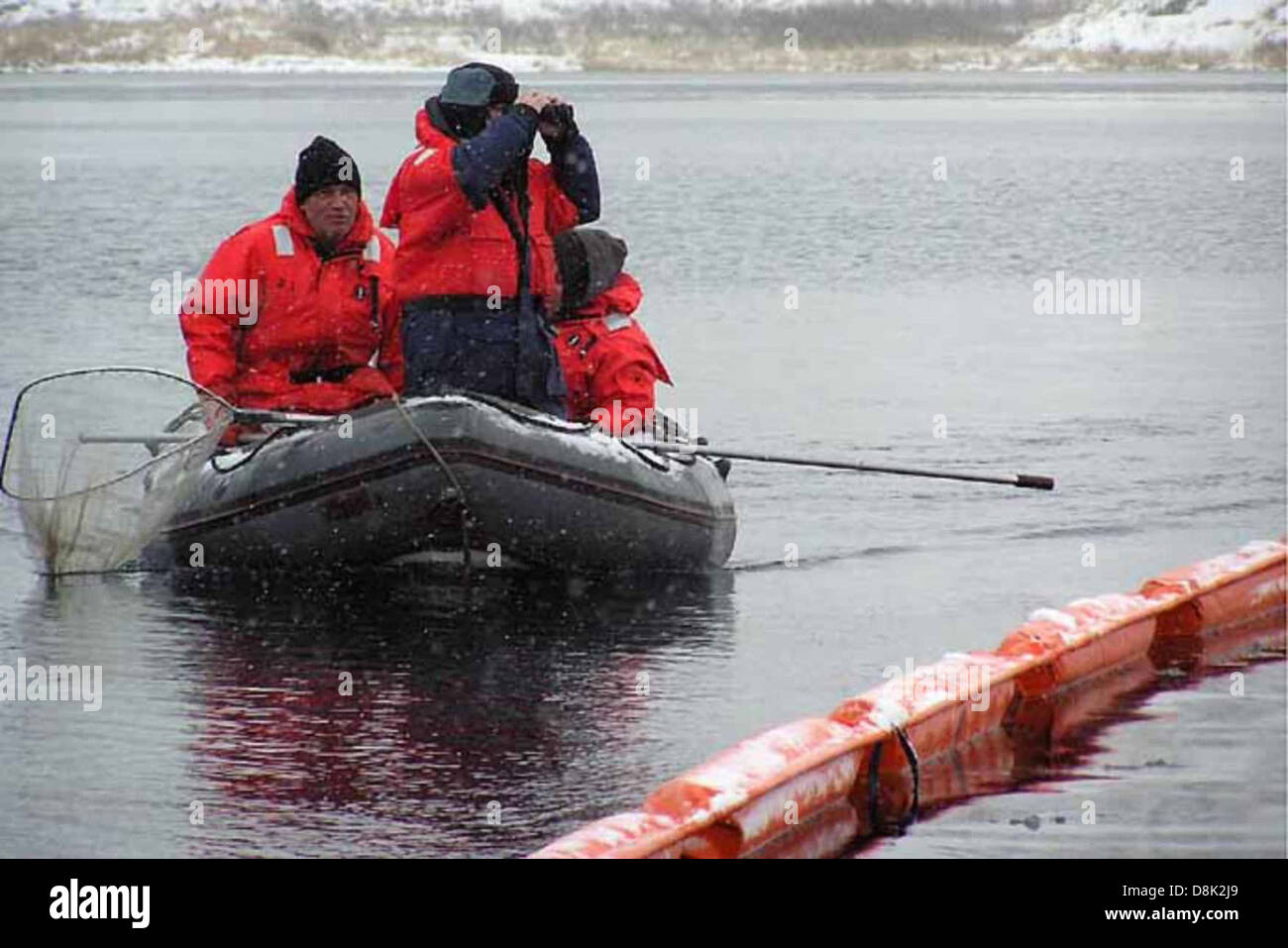 A search and rescue operation underway with people aboard a rescue boat ...
