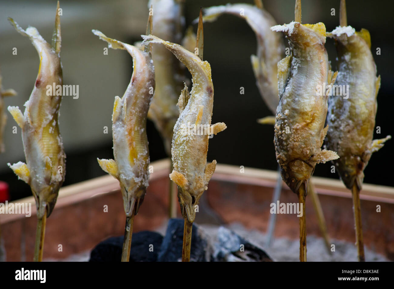 Street food. Fried Ayu fish on skewers sold in Nikko, Japan Stock Photo ...