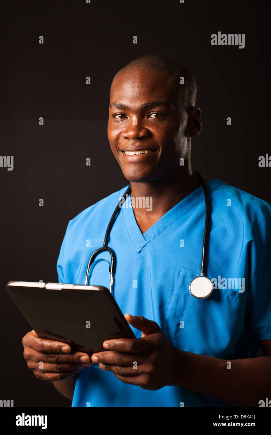 African American medical doctor with tablet computer over black ...