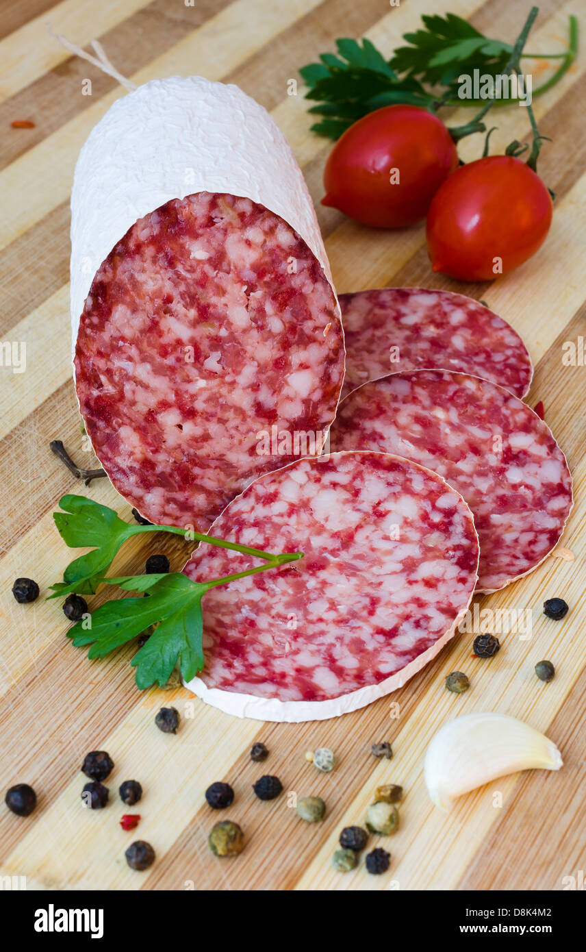 Still life with sliced romanian salami and vegetables Stock Photo - Alamy