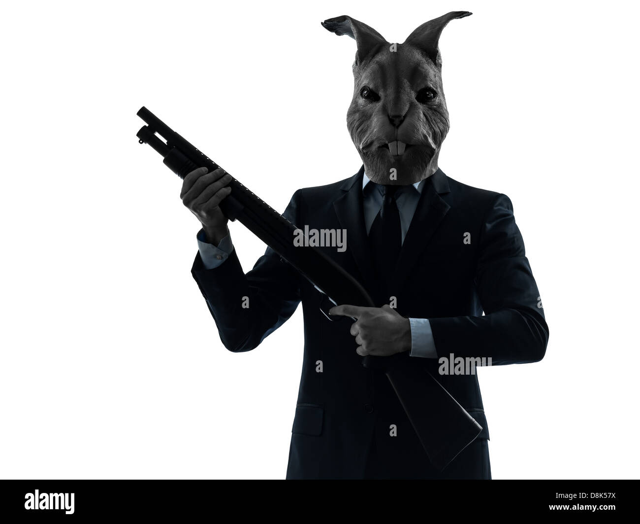 one man rabbit mask hunting with shotgun portrait in silhouette studio ...