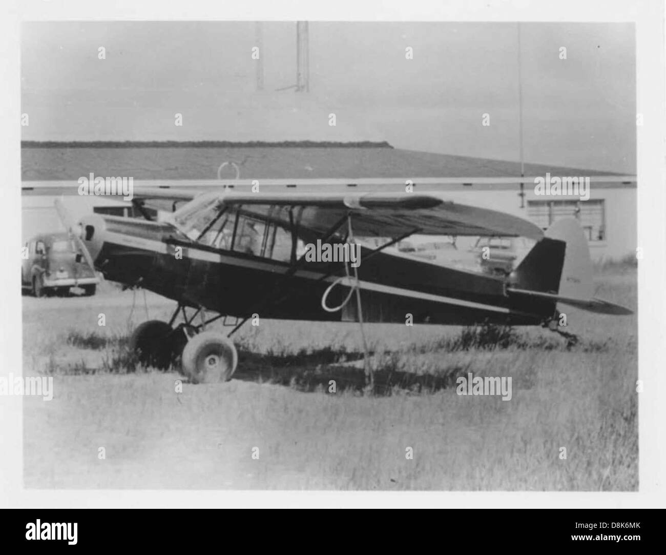 A historical image of a small vintage airplane, capturing the early ...