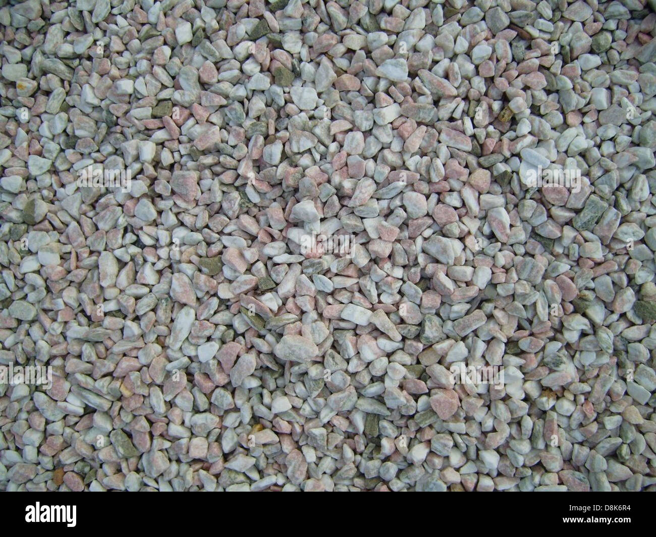 A close-up view of small pebbles scattered across a surface. The ...