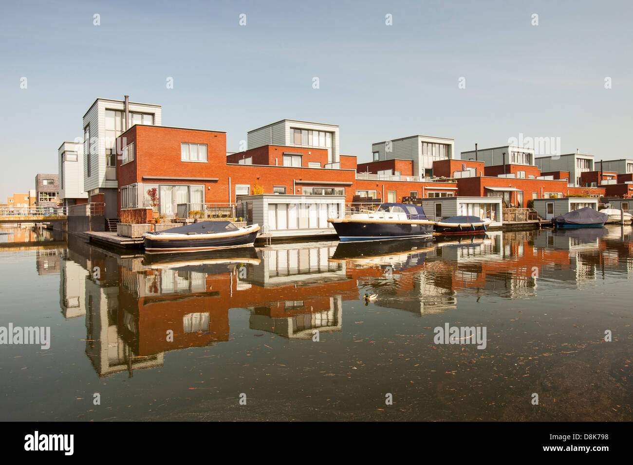 Houses in Almere next to canal. It is the Netherlands youngest town, in ...