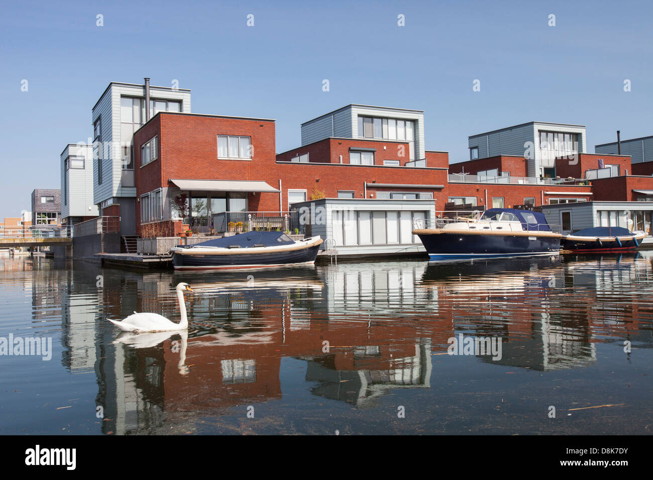 Houses in Almere next to canal. It is the Netherlands youngest town, in ...