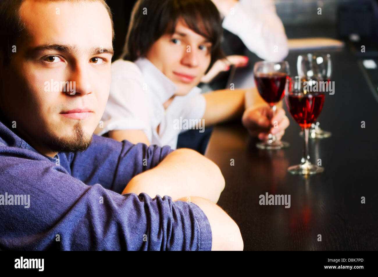 Young men relaxing at a bar counter Stock Photo - Alamy
