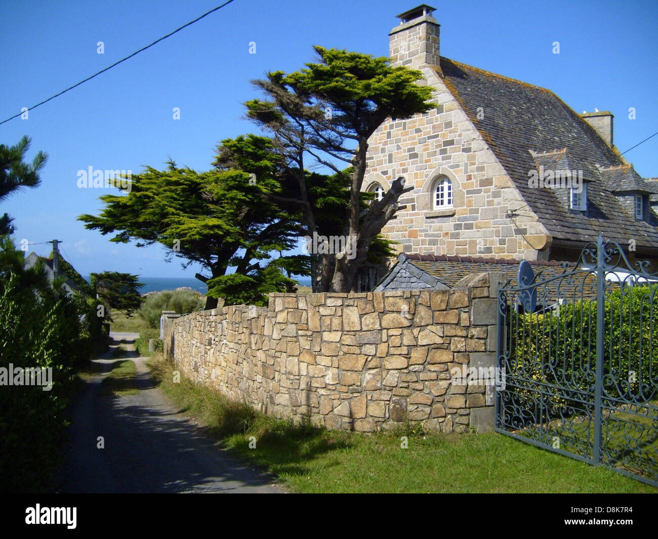 A stone house with a matching stone wall, showcasing the rustic and ...