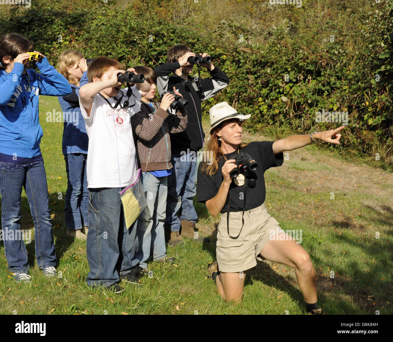 In this image, a group of students is learning about birding techniques ...