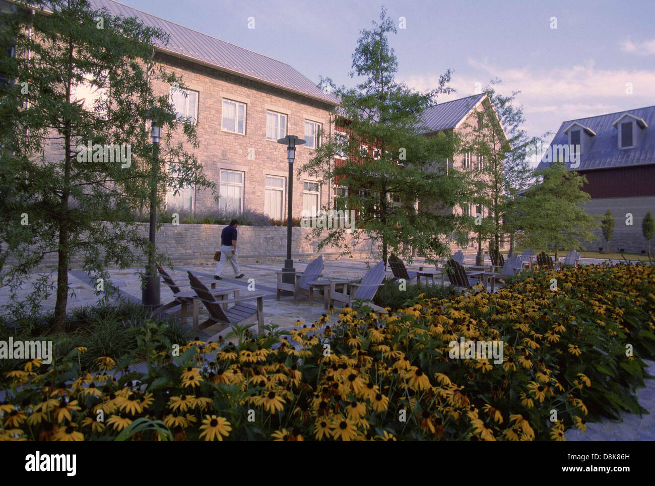 A student walks across a school patio, possibly heading to class. The ...