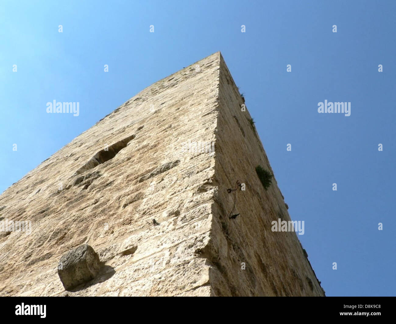 A tower made of stacked stones stands tall, often as part of a ...