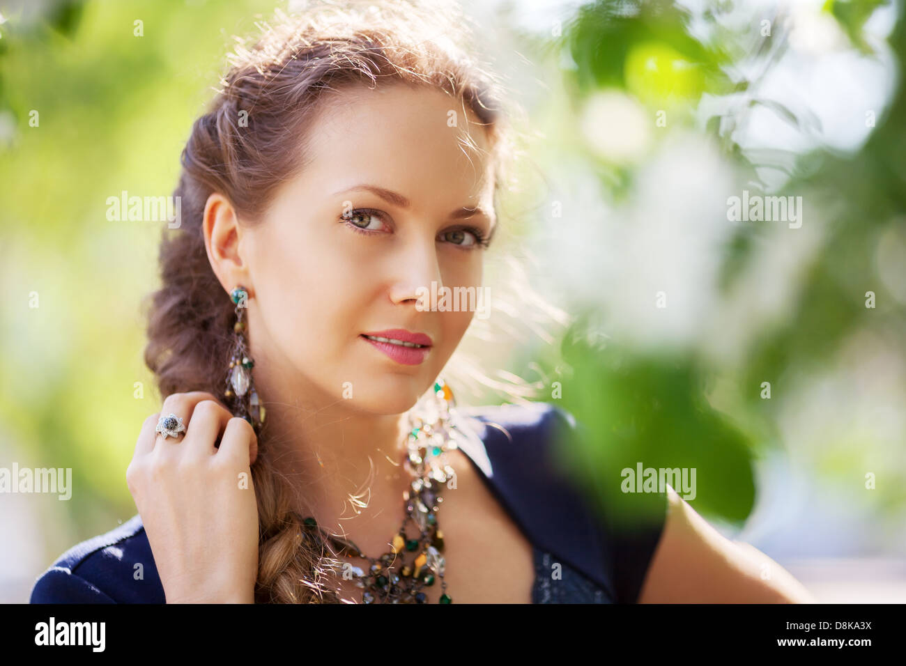 Beautiful woman in a spring garden Stock Photo - Alamy