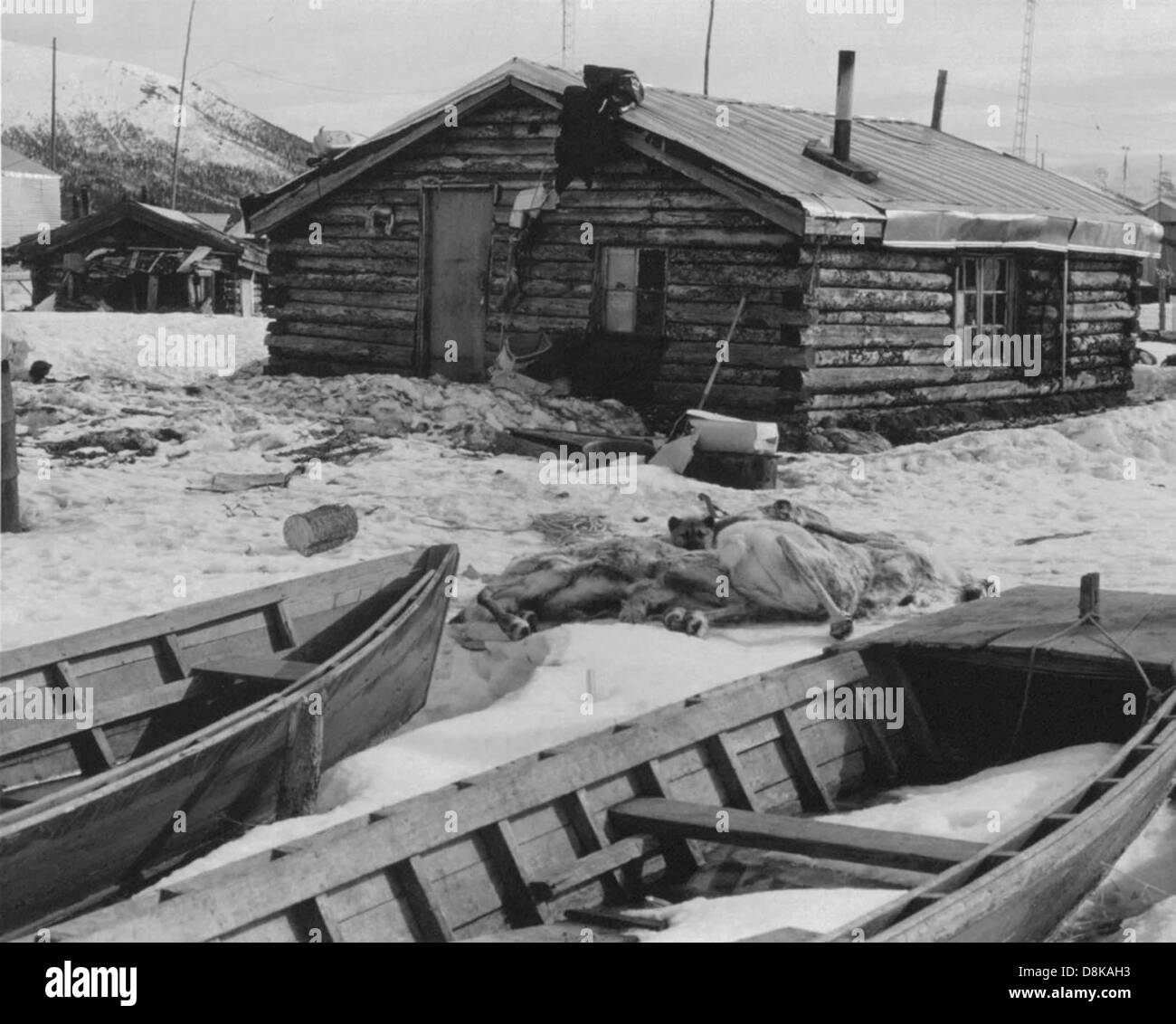 A vintage photo depicting a village scene, likely from a past era. The ...